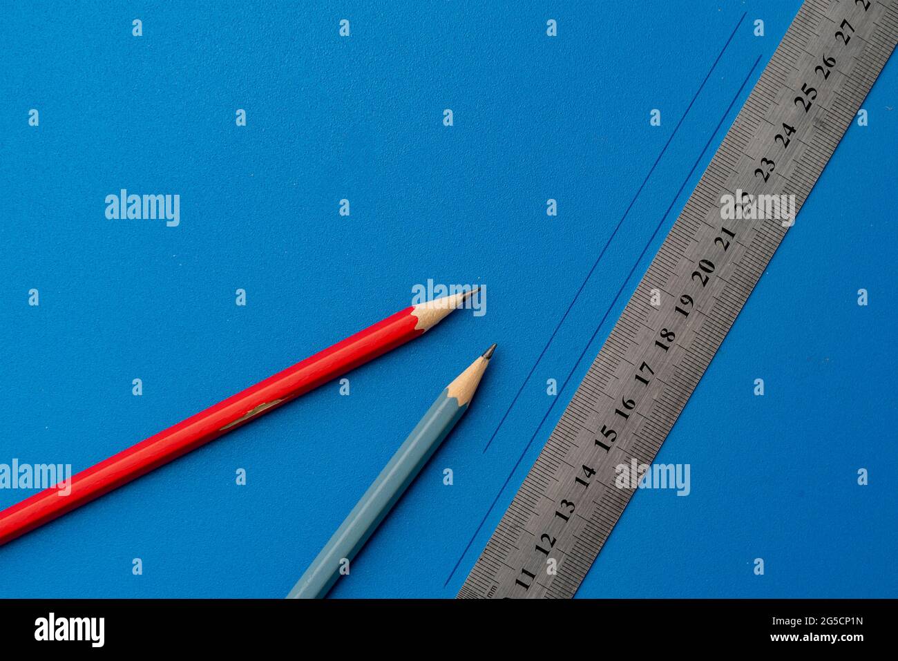 drawing a line on a color surface with a ruler and pencil Stock Photo ...