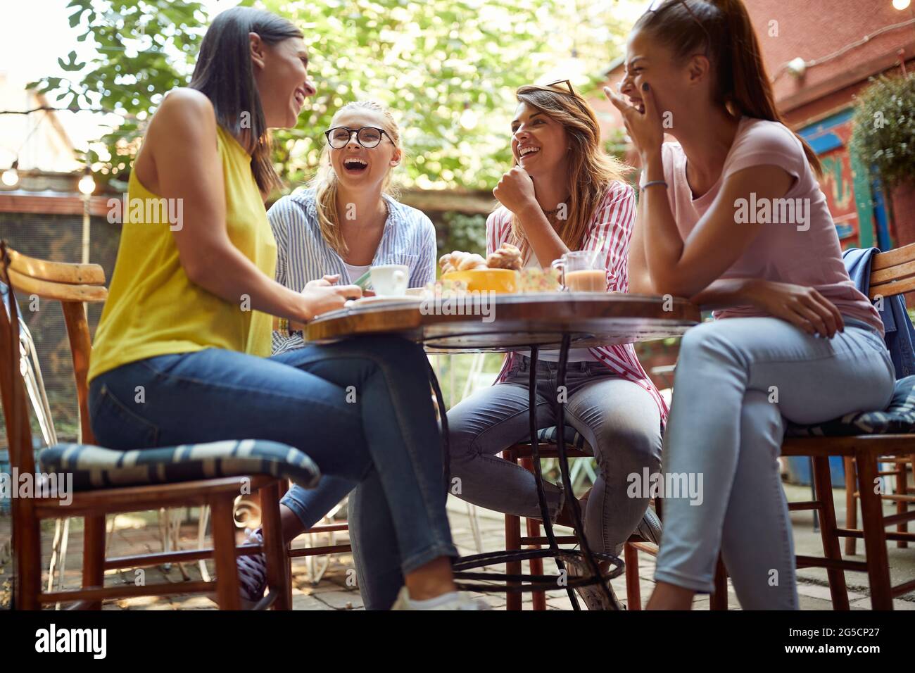 Group of people sitting together hi-res stock photography and images ...