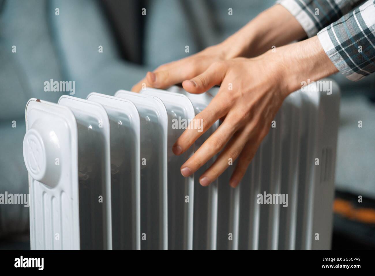 feeling cold, getting warm, hands touching the heater close up Stock ...