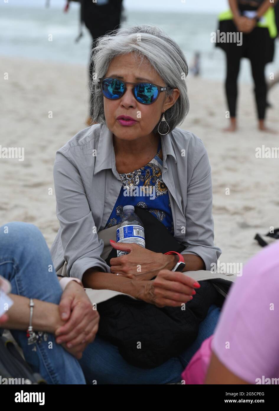 Surfside FL, USA. 25th June, 2021. Family members gather on the beach ...