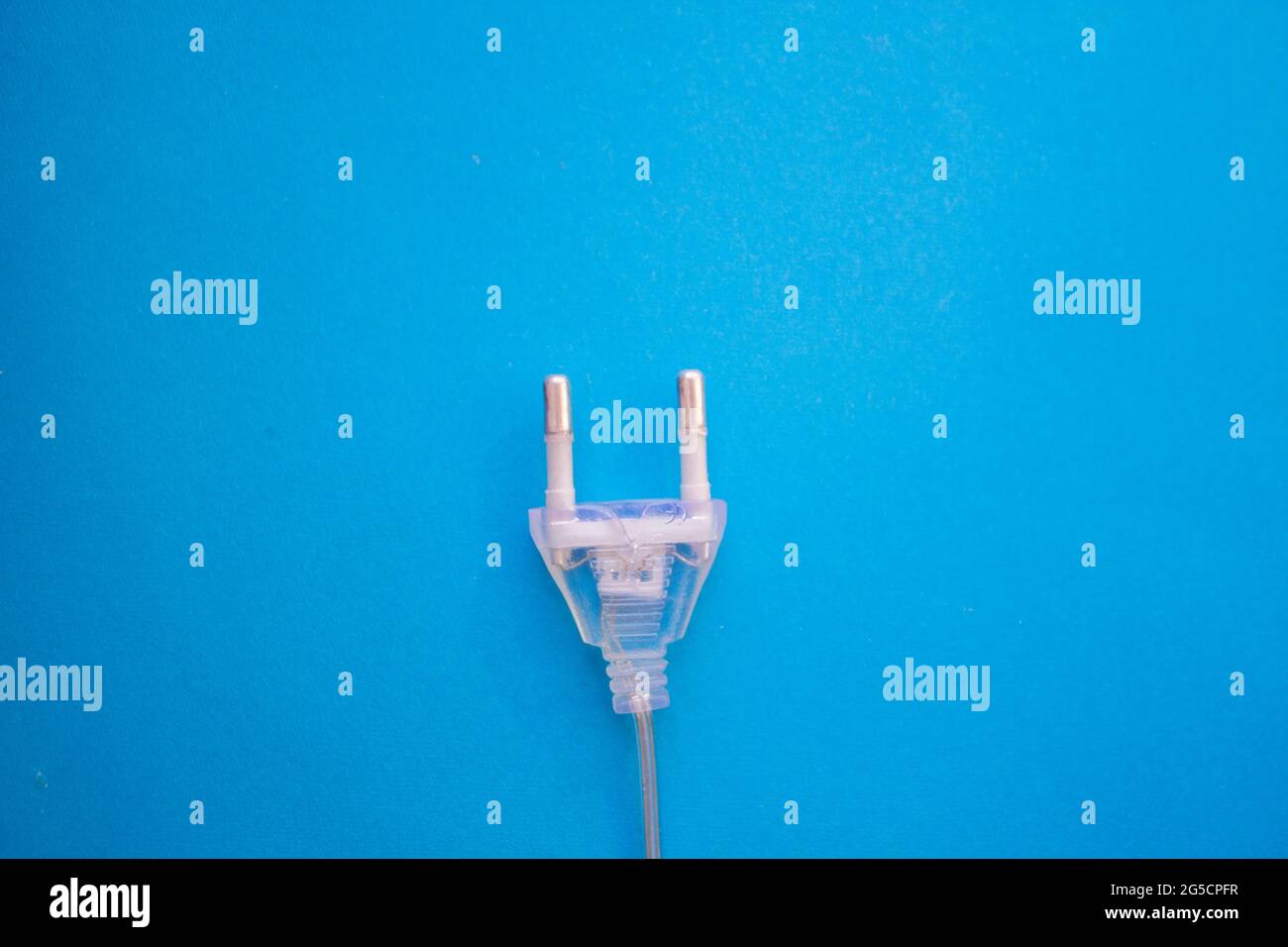 White electric plug on the blue background with copy space Stock Photo ...