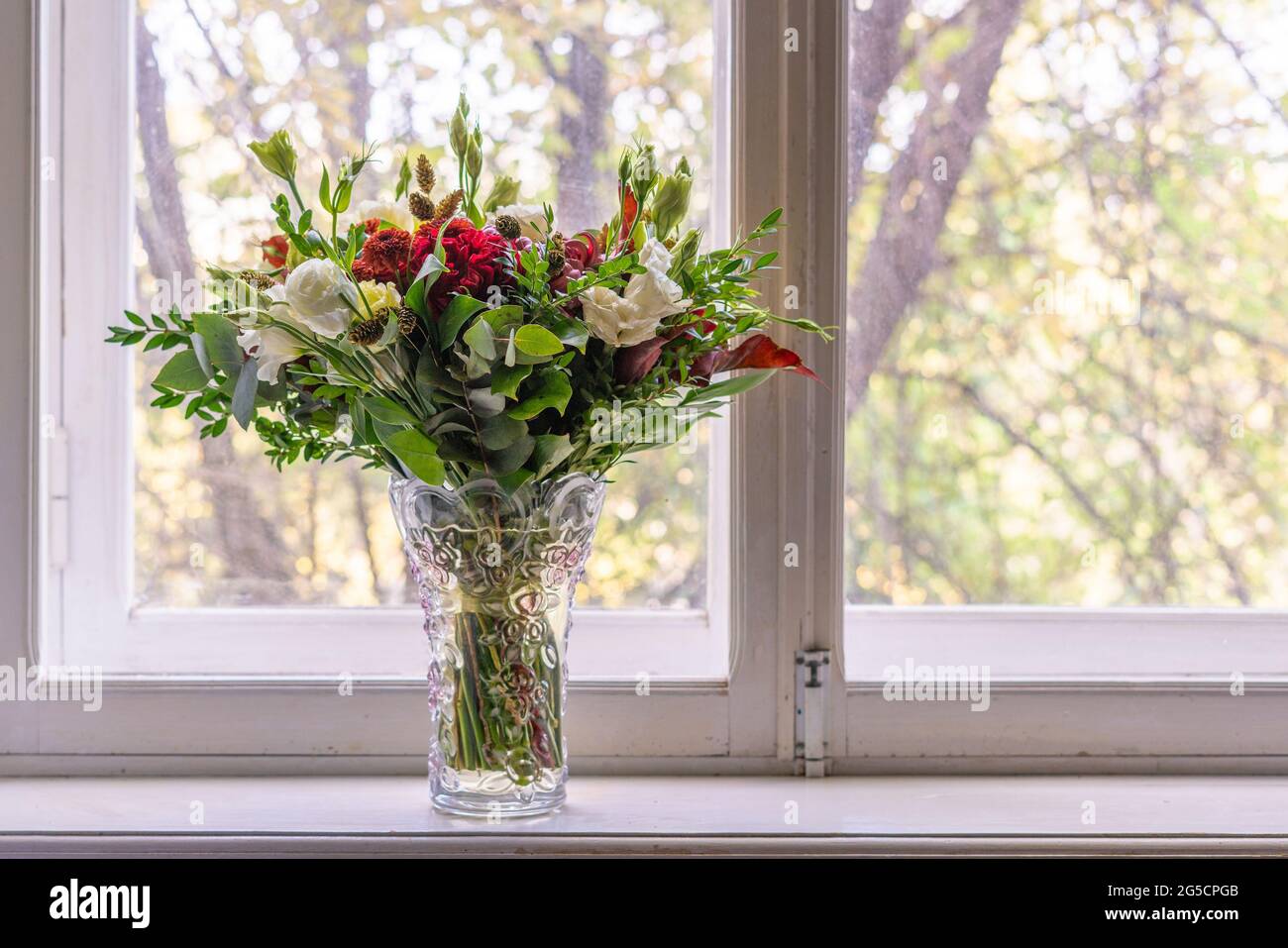 a gorgeous bouquet of the various flowers standing next to the window ...