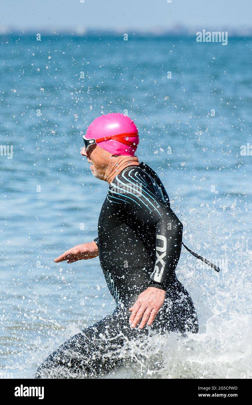 Brighton, UK. June 26th 2021 A swimmer enters the water for the ...