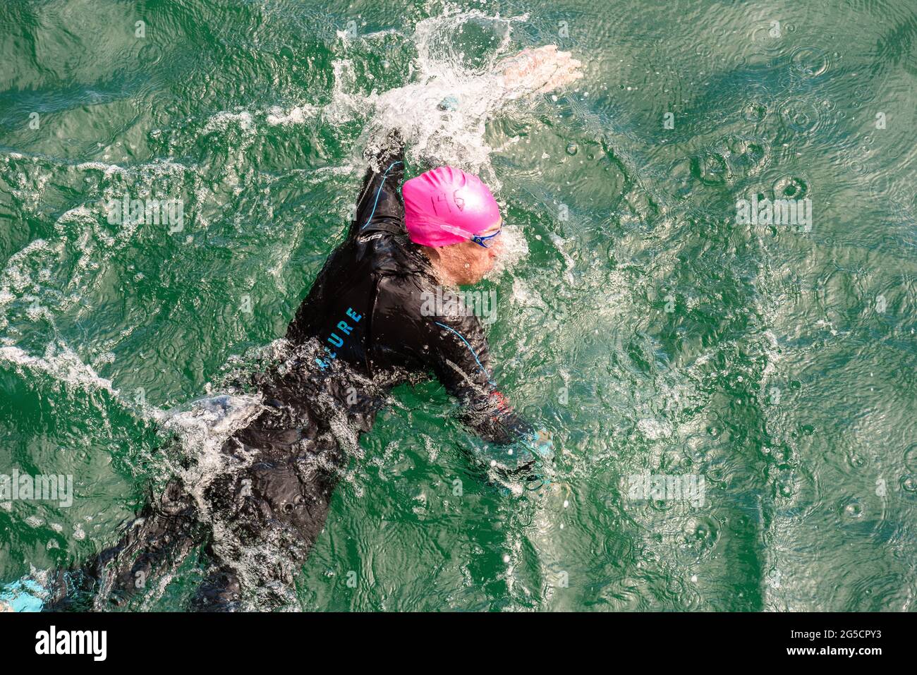 Brighton, UK. June 26th 2021 A swimmer crosses the finish line under ...