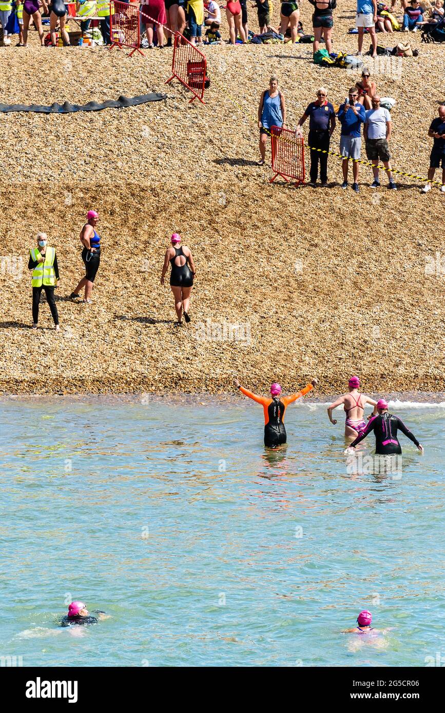 Brighton, UK. June 26th 2021 Swimmers come ashore by Brighton Pier ...