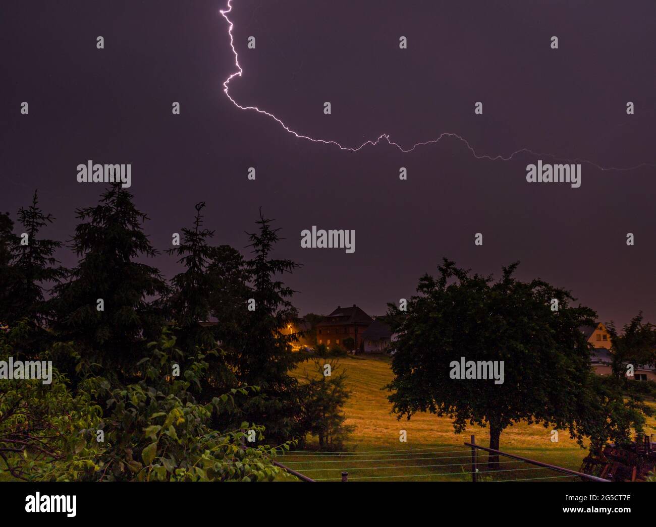 Lightning over a village during a thunderstorm Stock Photo - Alamy