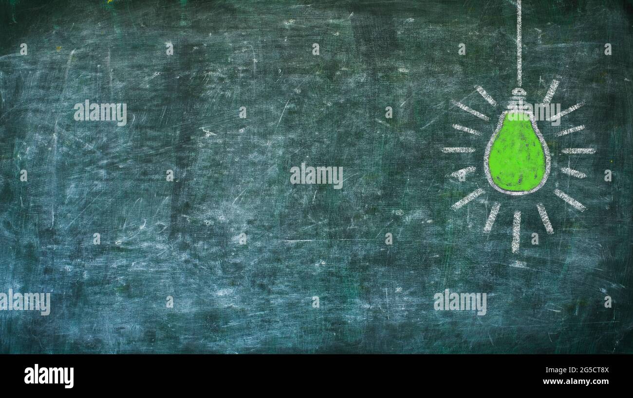 renewable energy and power concept,green lightbulb on black board ...