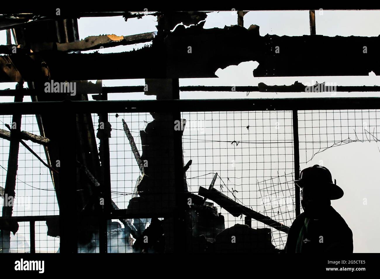 Quezon City. 26th June, 2021. A firefighter is seen on a fire scene at ...