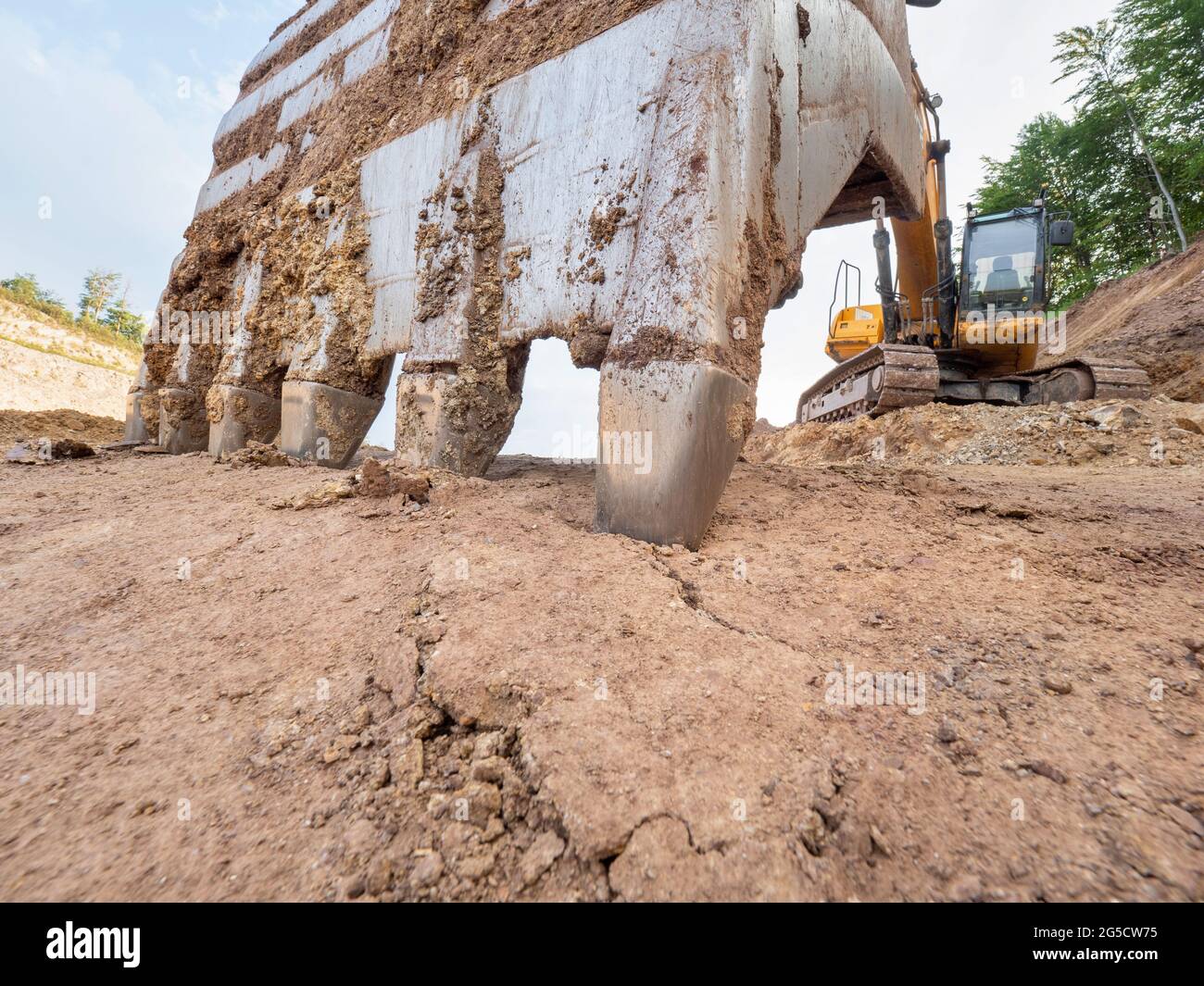 Large loader bucket with sharp teeth. Industrial track type excavator ...
