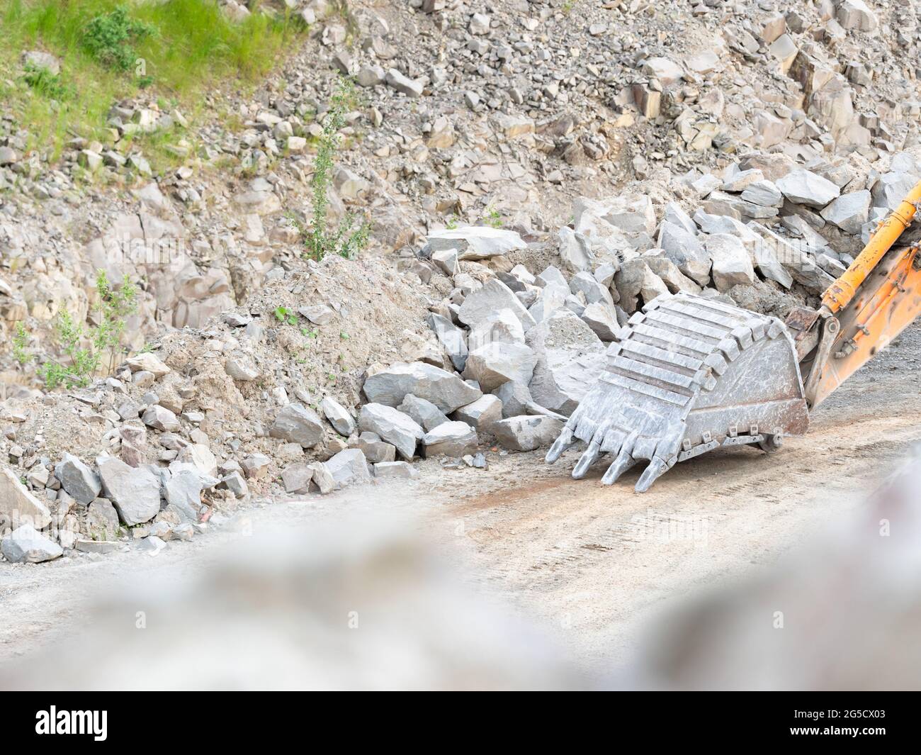 Detail of an excavator bucket. Backhoe bucket digging the soil. Crawler ...