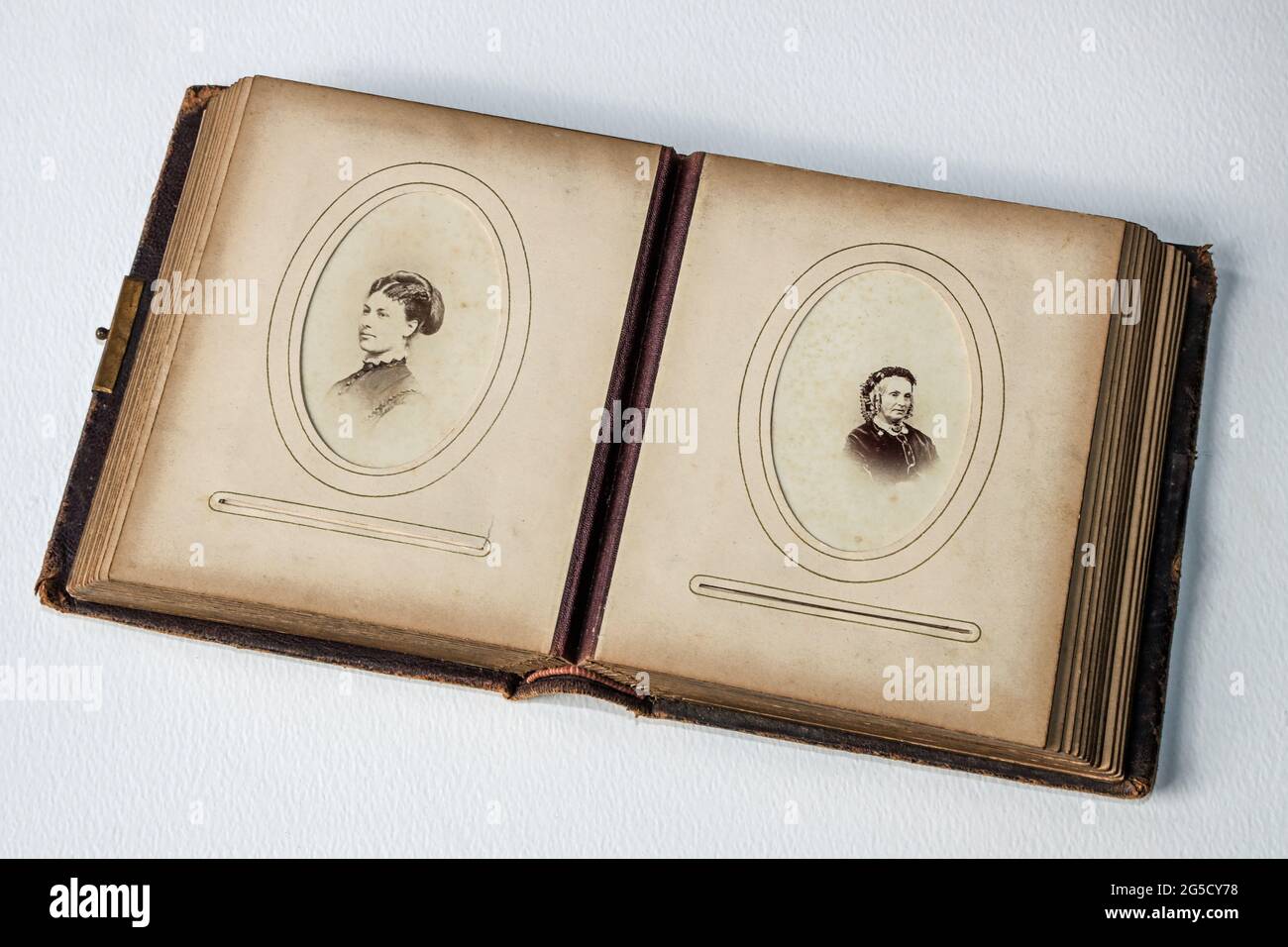 An antique photo album on a plain white textured watercolour paper ...