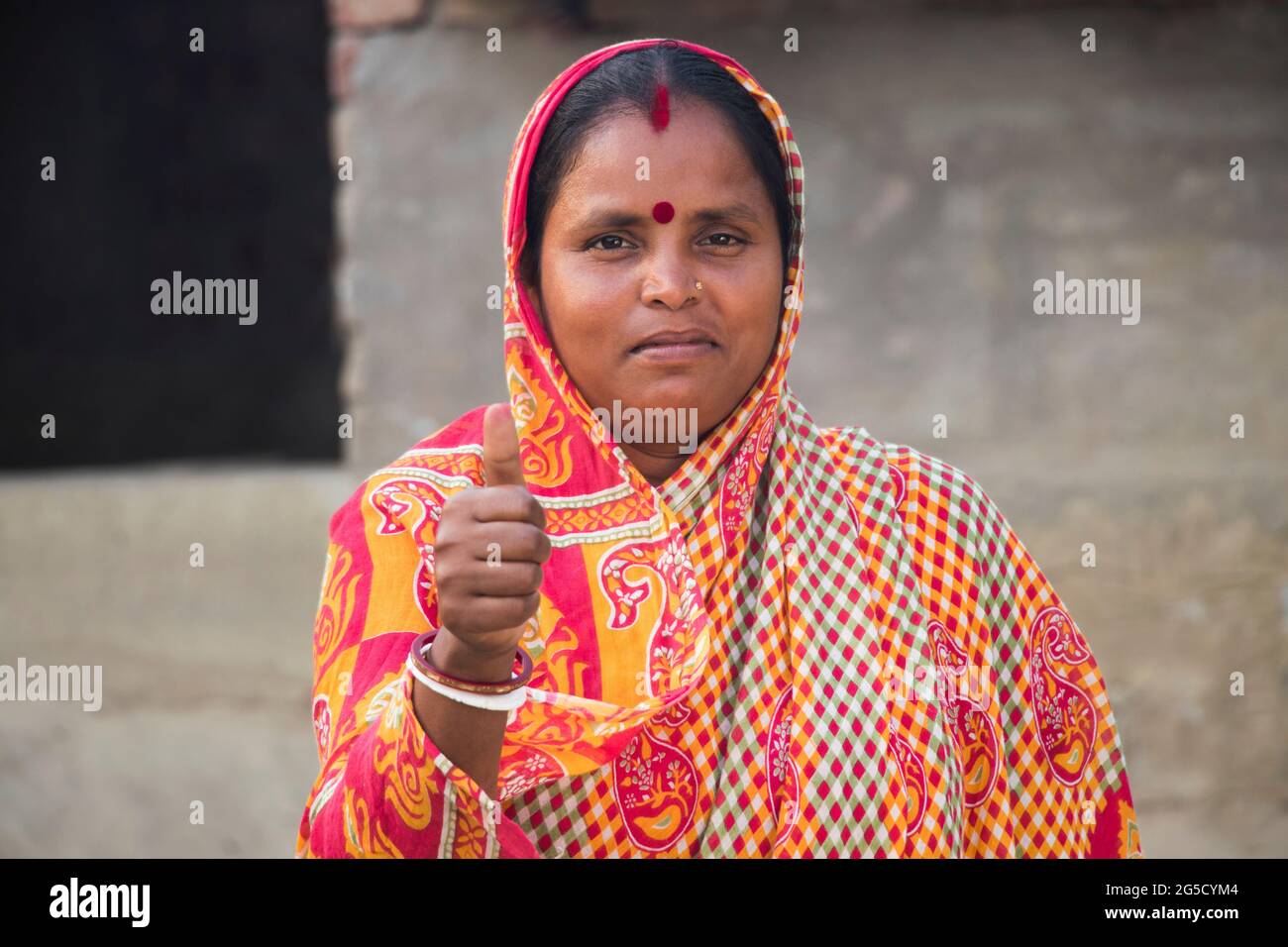Indian Rural Woman showing thumbs up sign Stock Photo - Alamy