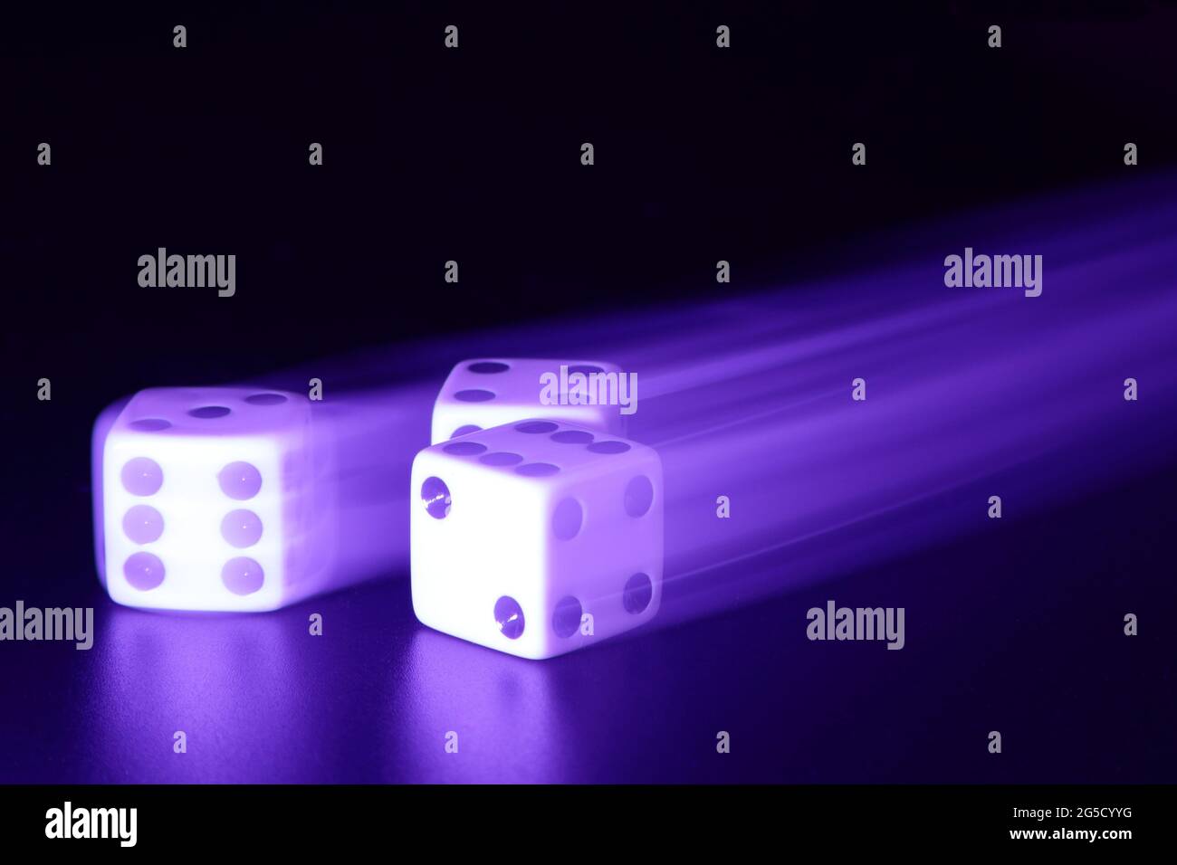 Three dice with motion blur Stock Photo - Alamy