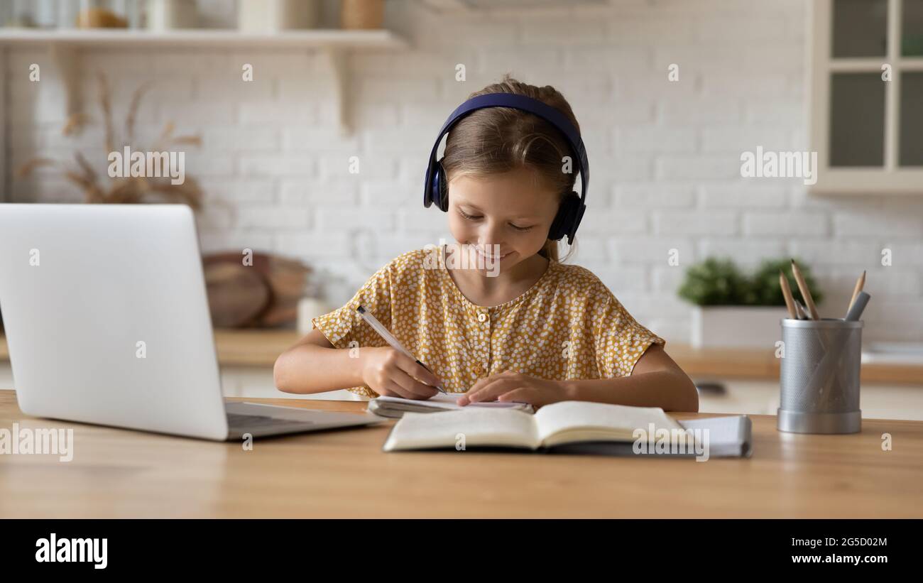 Happy adorable little 7s child enjoying e-learning Stock Photo - Alamy