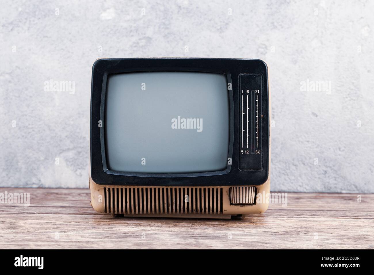 Old vintage retro analog TV set stand on wooden floor front aged ...