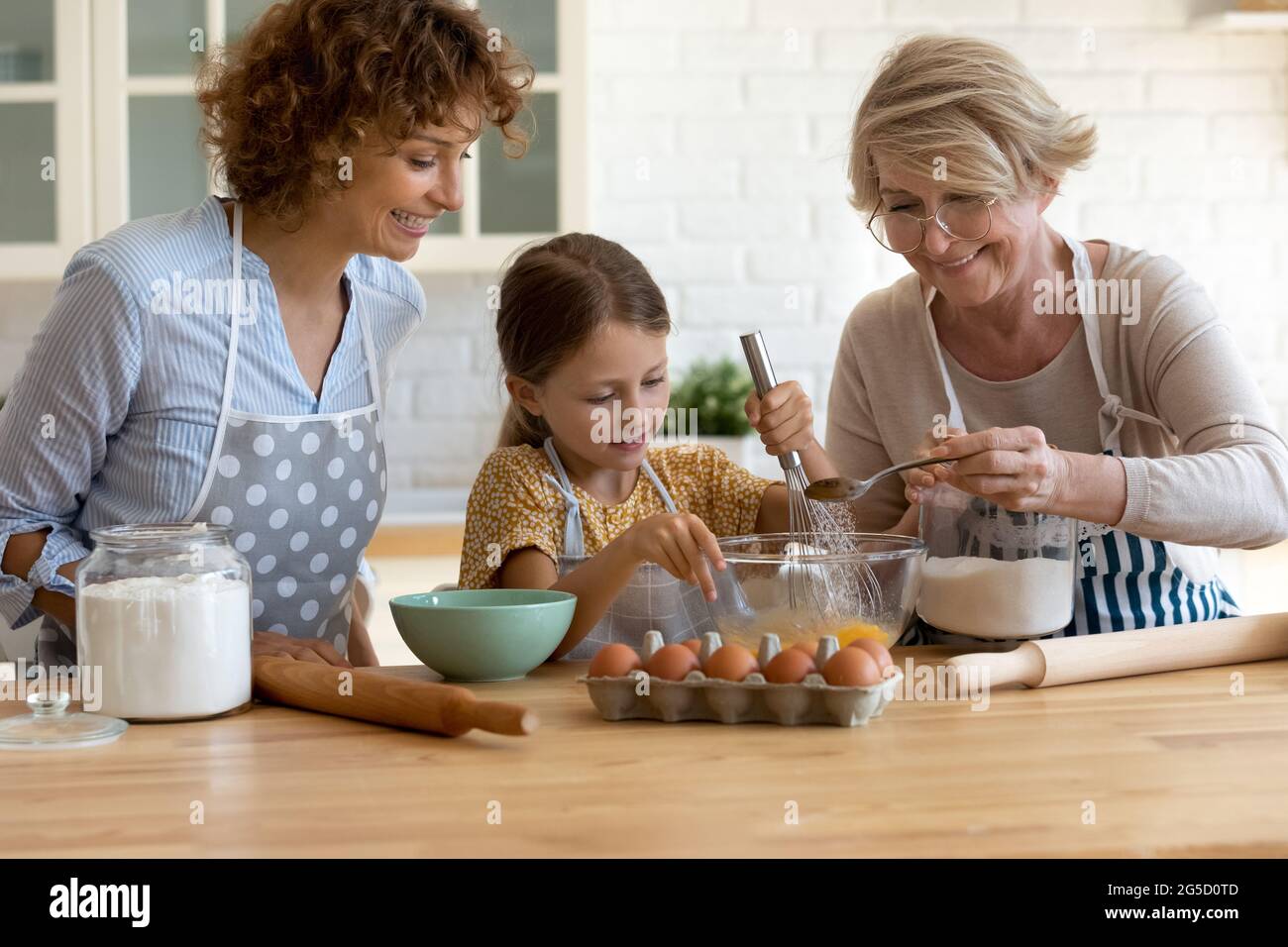Happy family preparing homemade pastry in kitchen Stock Photo - Alamy