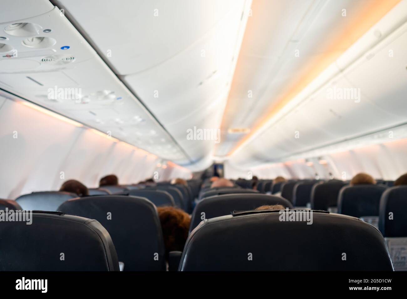 Passengers Inside the cabin of aircraft sitting on the chairs during ...