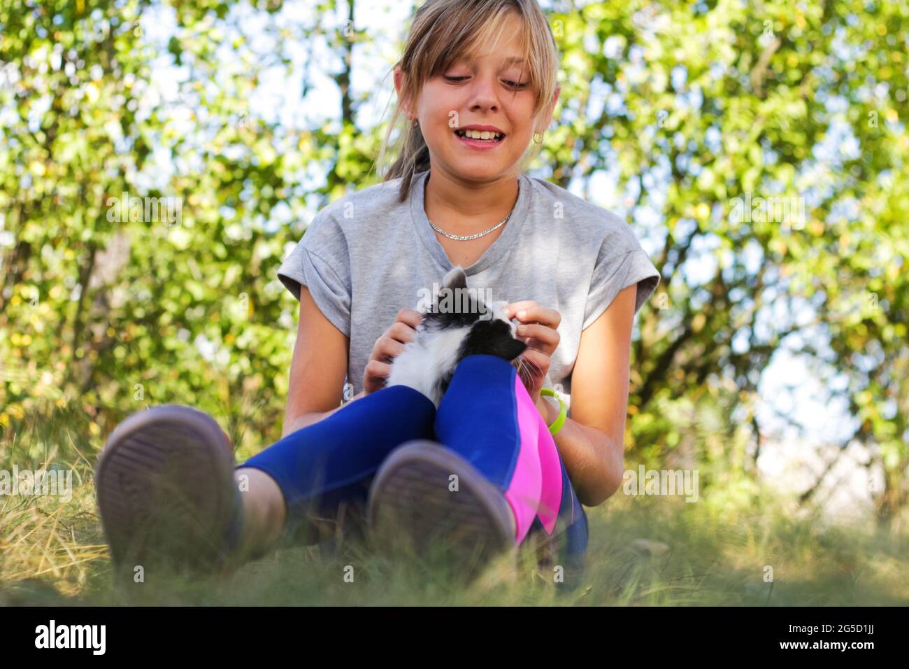 Defocus little expression girl playing and caress cat, black and white ...