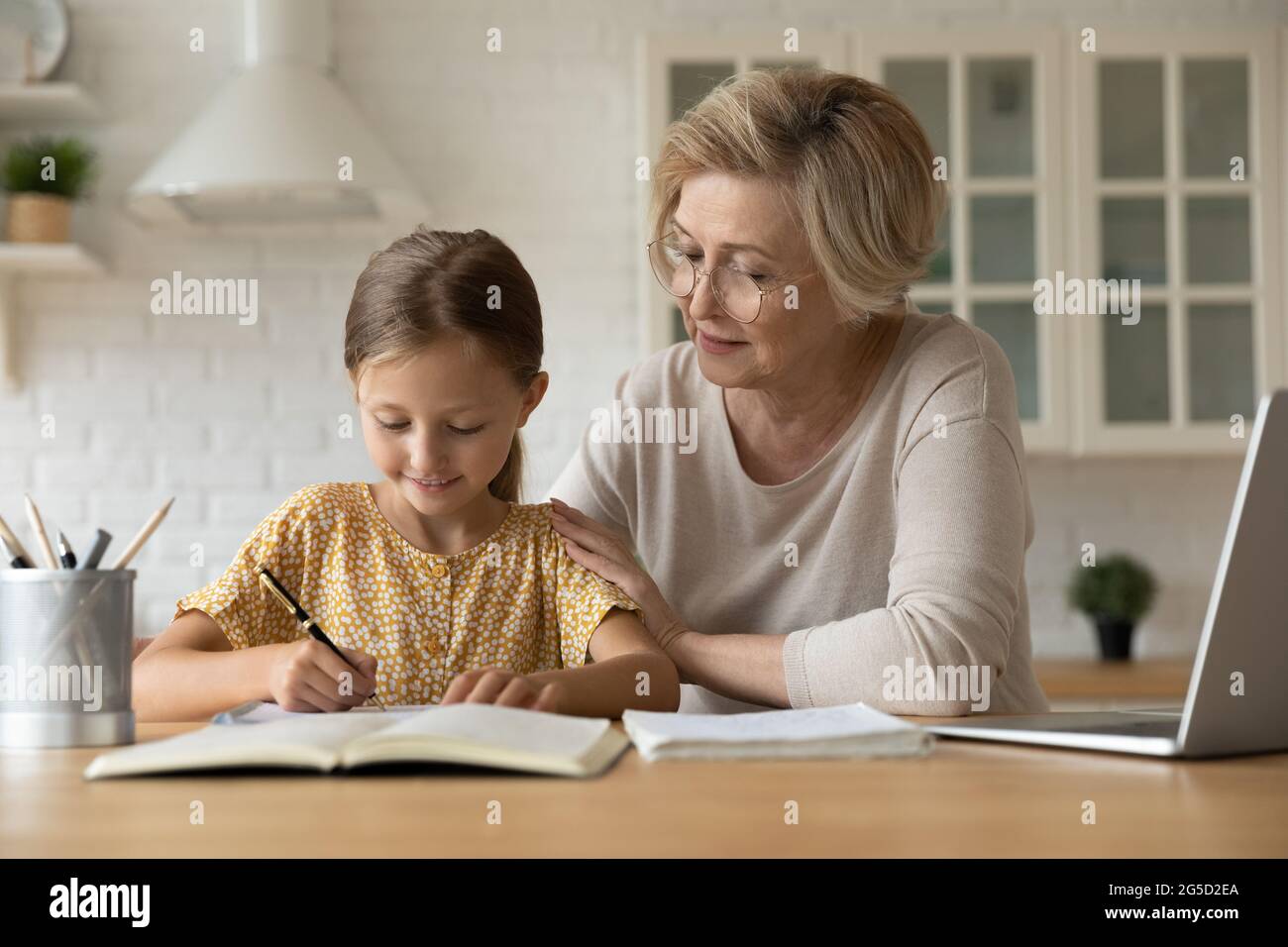 Child helping elderly hi-res stock photography and images - Alamy