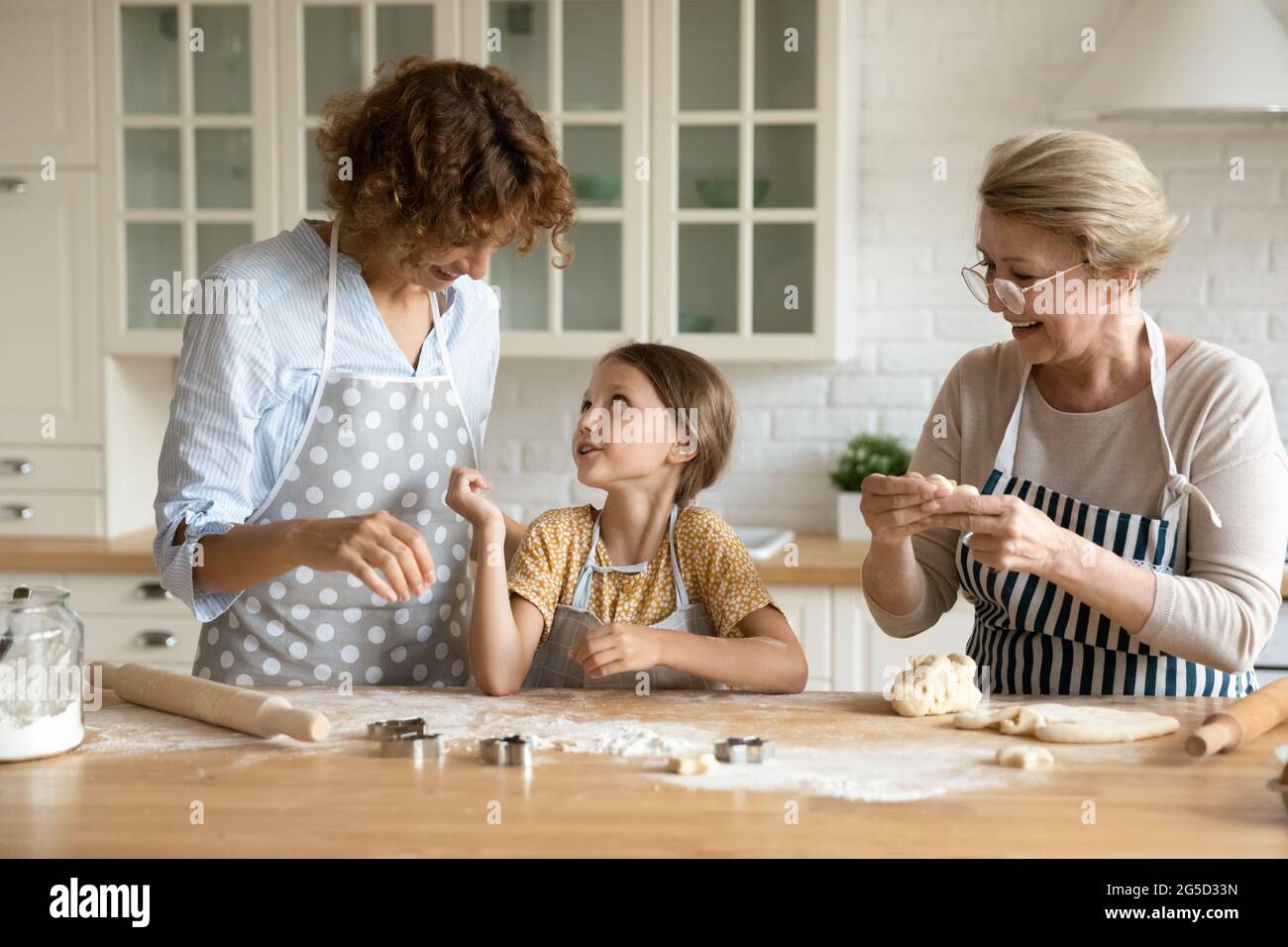 Happy family enjoying cooking together on weekend Stock Photo - Alamy