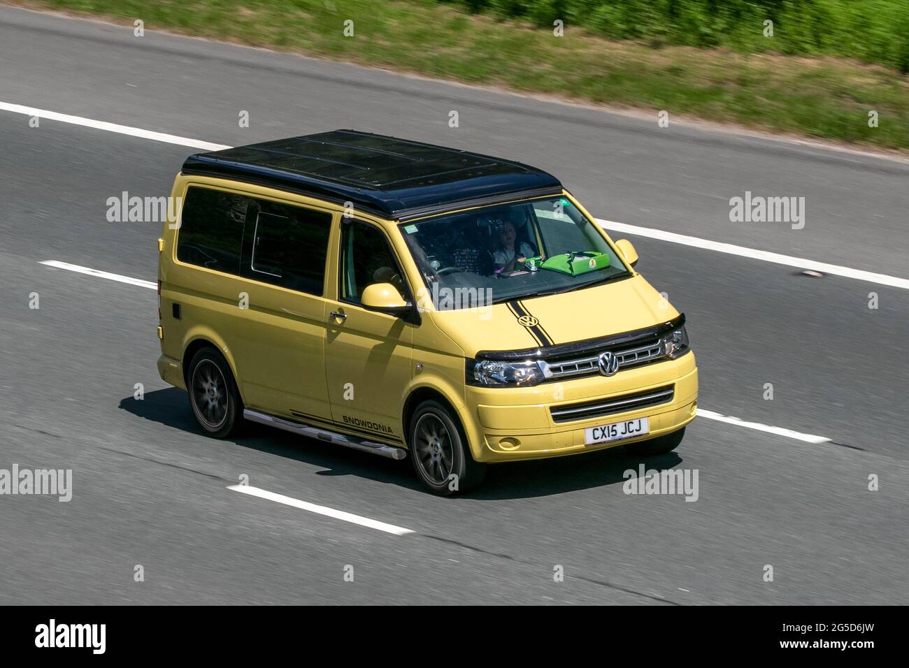 A Yellow Diesel Volkswagen Transporter T28 St-Line Panel Van driving on ...