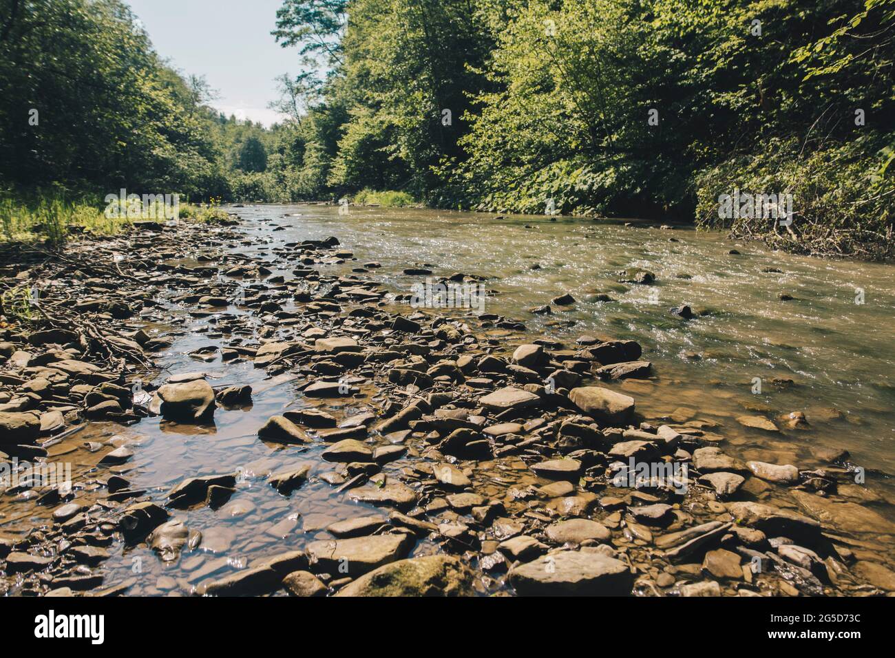 landscape with a river in a hilly terrain with rocks Stock Photo - Alamy