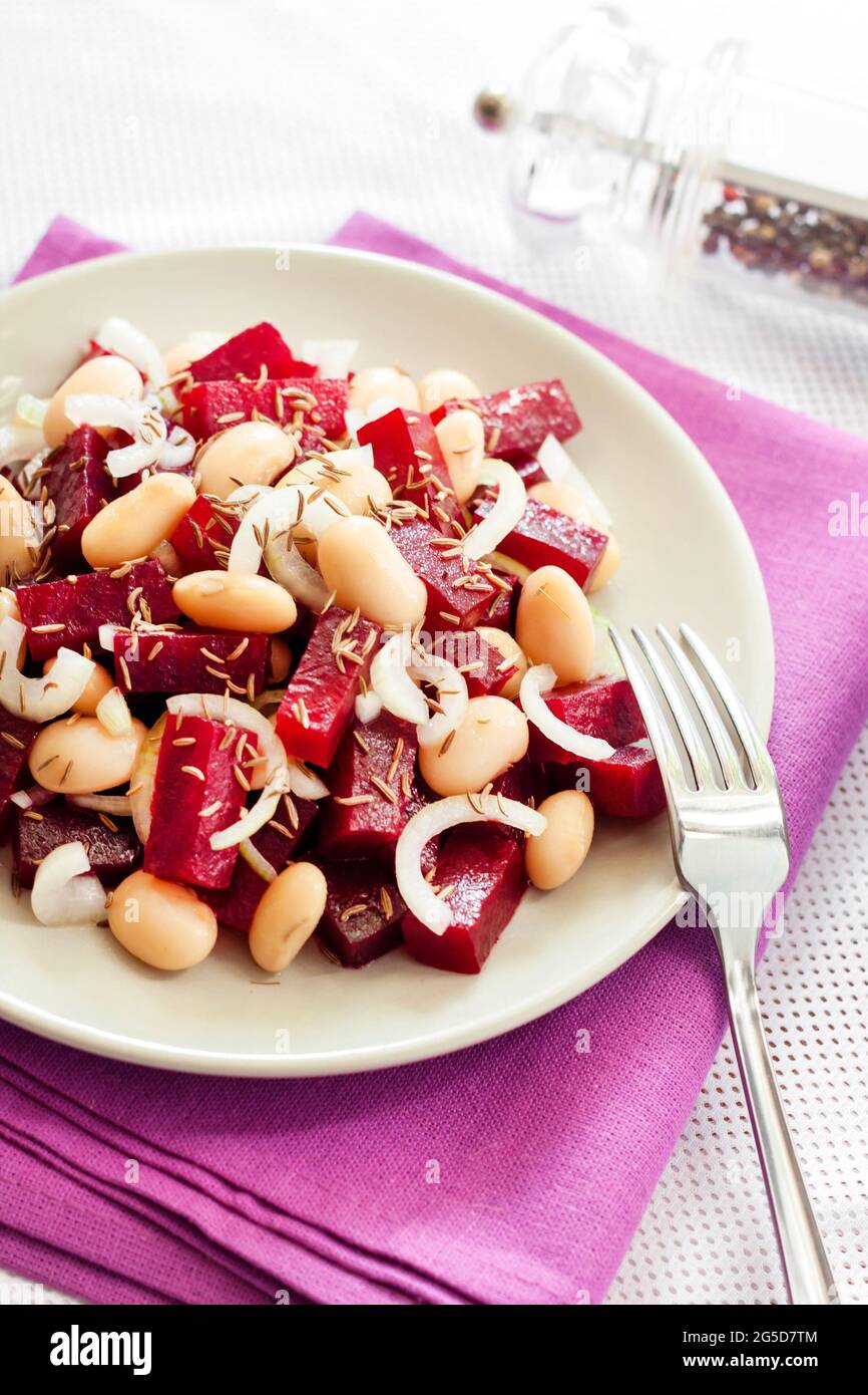 Beetroot salad with white kidney beans, pickles and onion, dressed with ...
