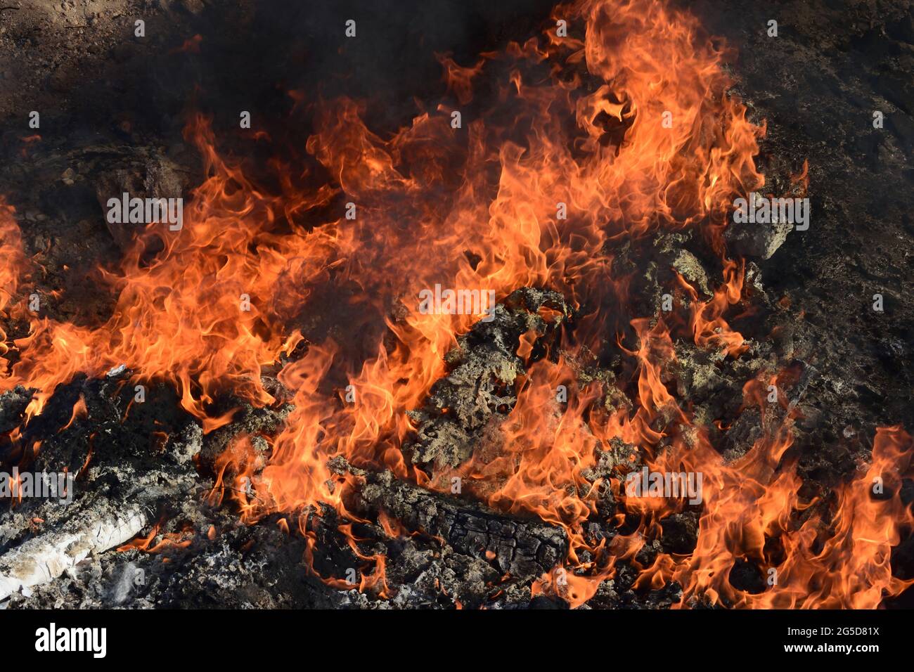 View of fire with black smoke due to burning garbage Stock Photo - Alamy