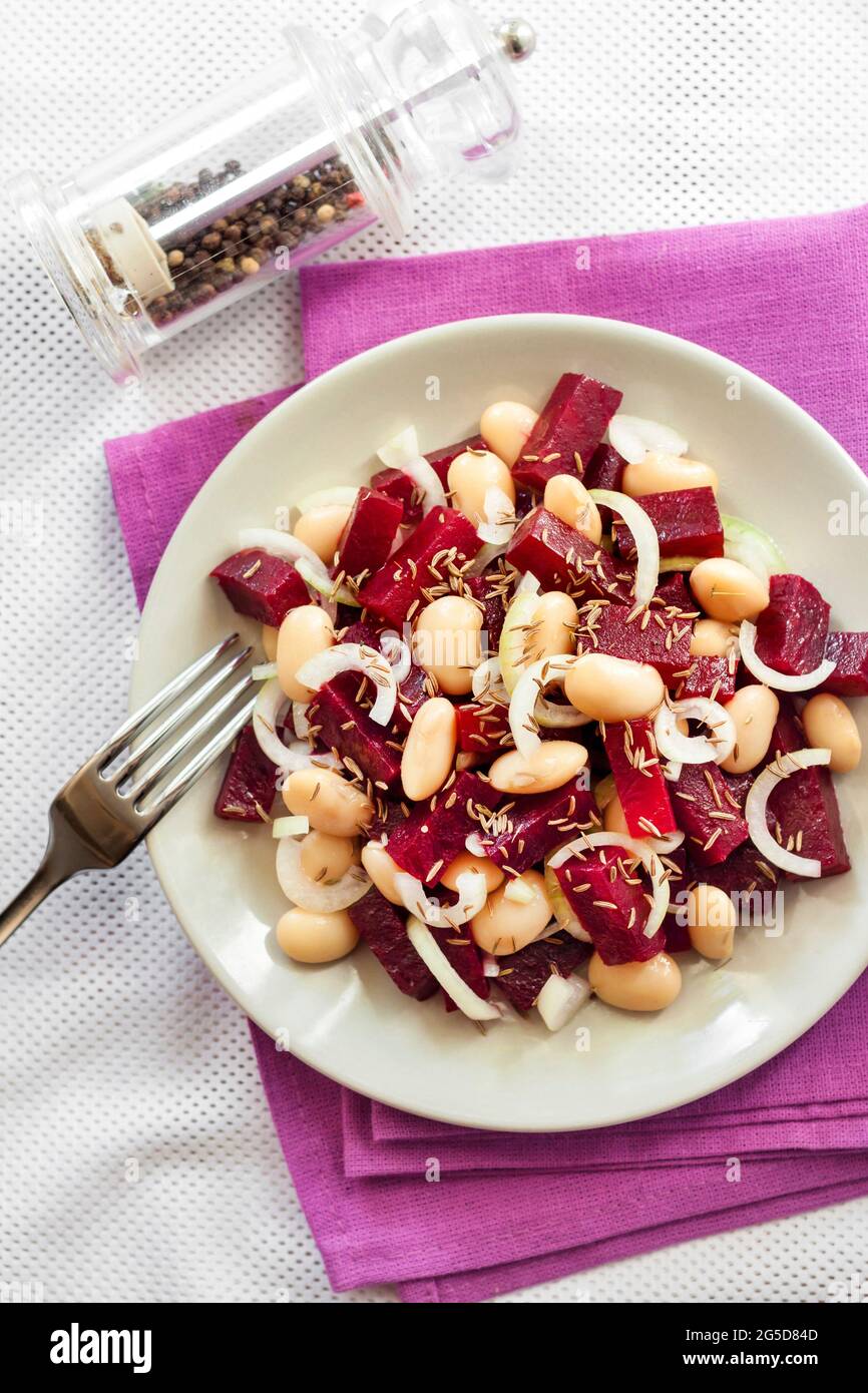 Beetroot salad with white kidney beans, pickles and onion, dressed with ...