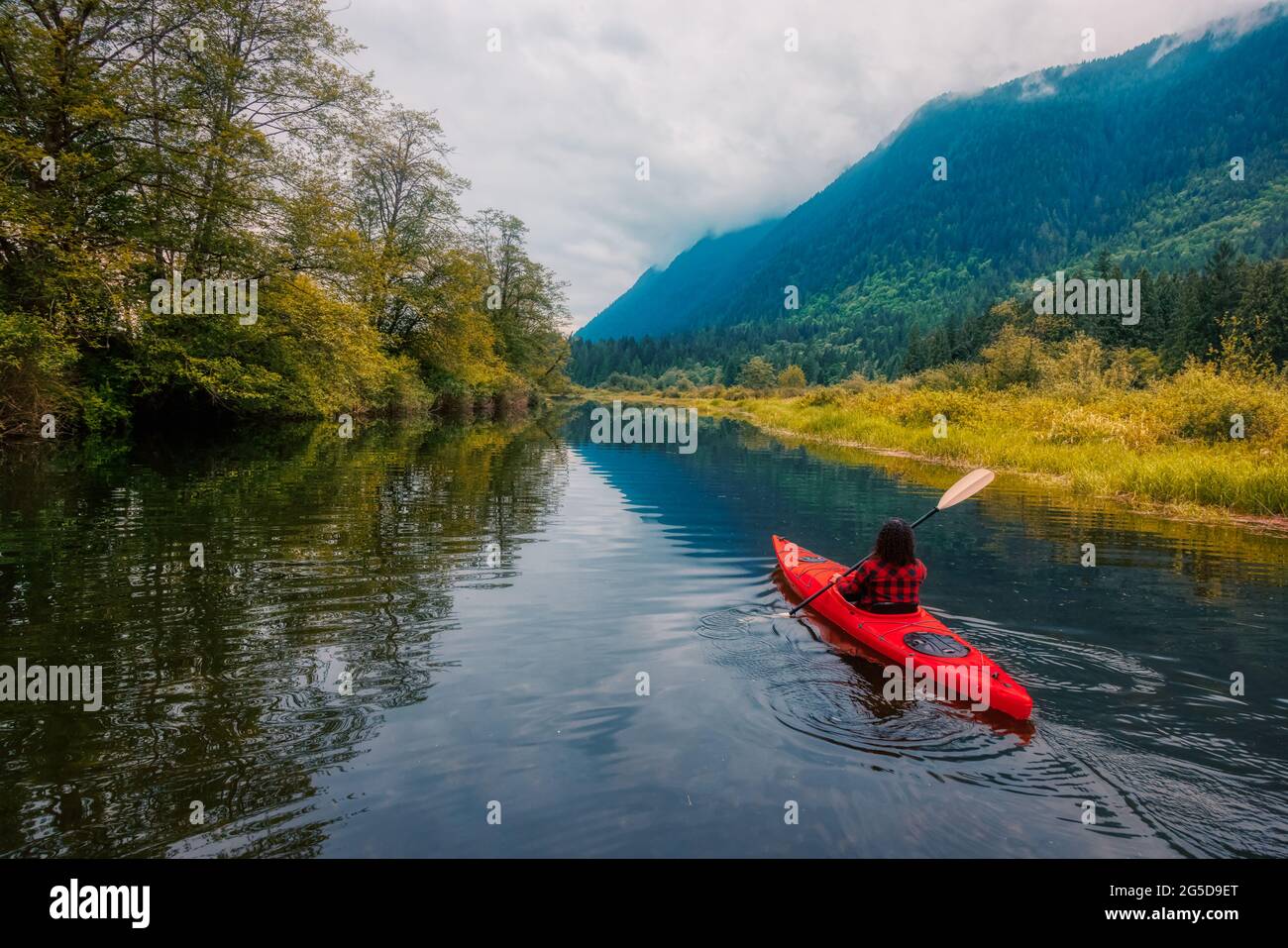 Adventure Caucasian Adult Woman Kayaking in Red Kayak Stock Photo - Alamy
