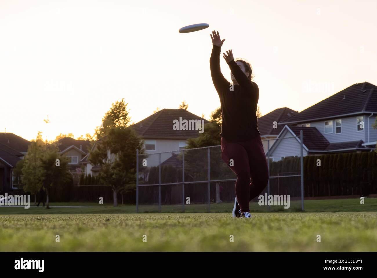 White Caucasian Adult Girl Playing Frisbee in the Green Field Stock ...