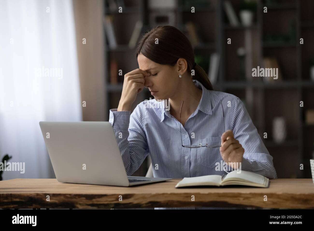 Overwhelmed unhappy young business woman taking off eyeglasses Stock ...