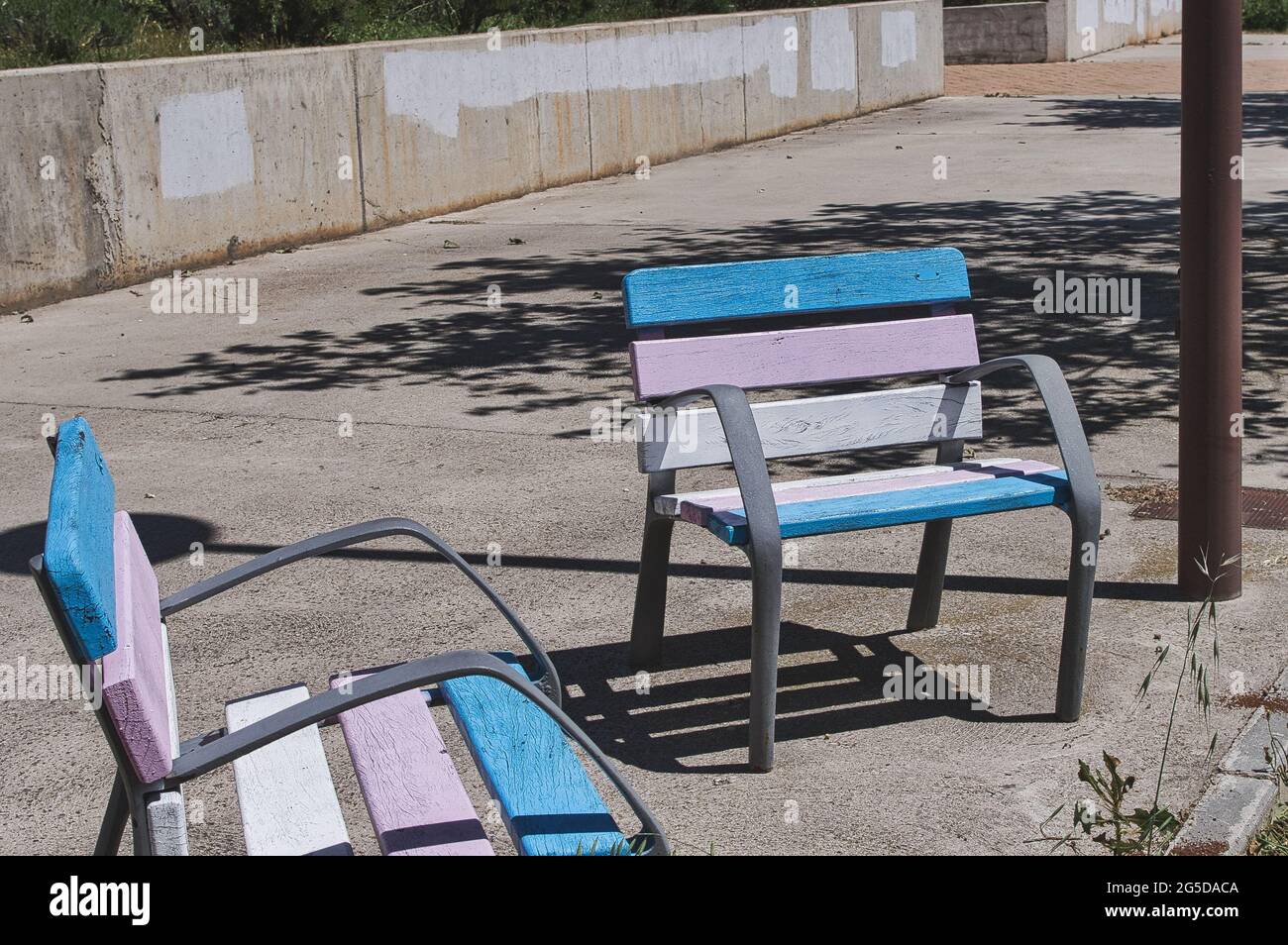 Benches with transgender flag colors in the park Stock Photo - Alamy