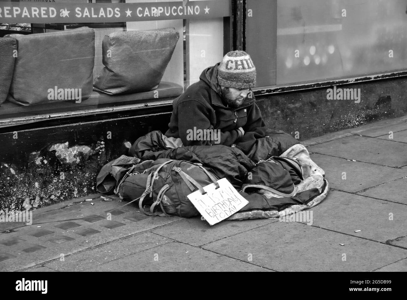 Sitting beggar Black and White Stock Photos & Images - Alamy