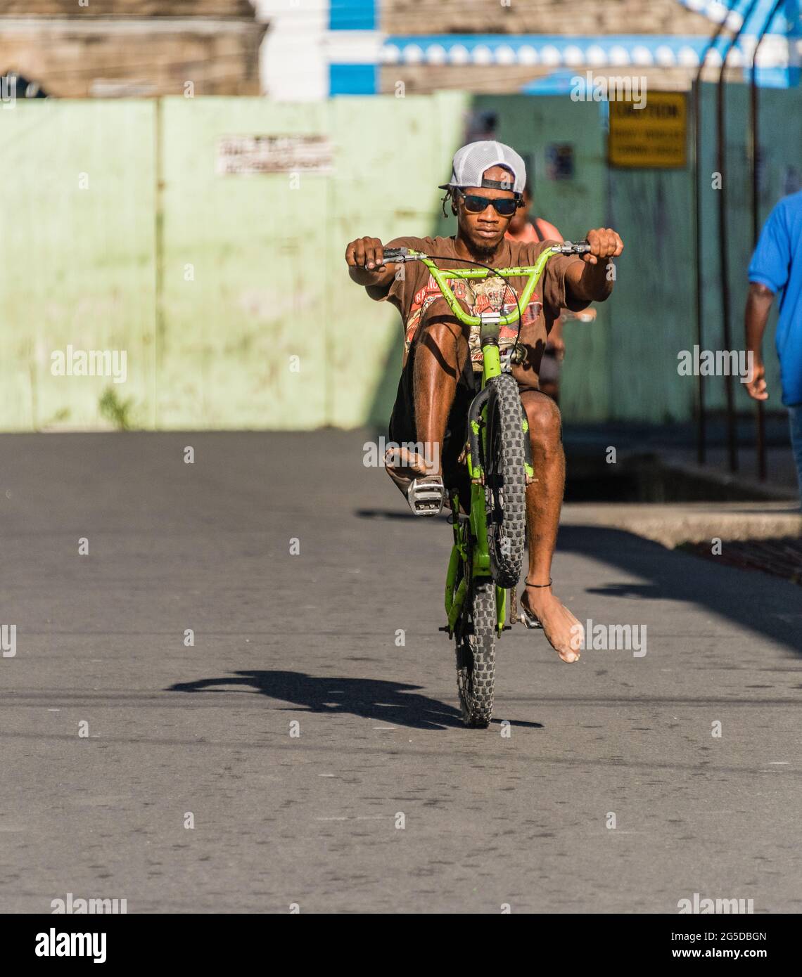 Caribbean cyclists doing wheelies Stock Photo - Alamy