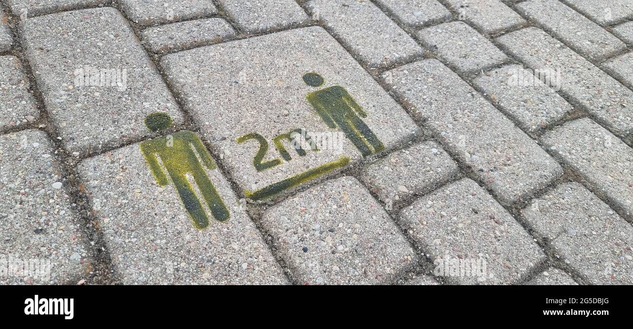 Two meters distance observation sign painted on the pavement of the ...