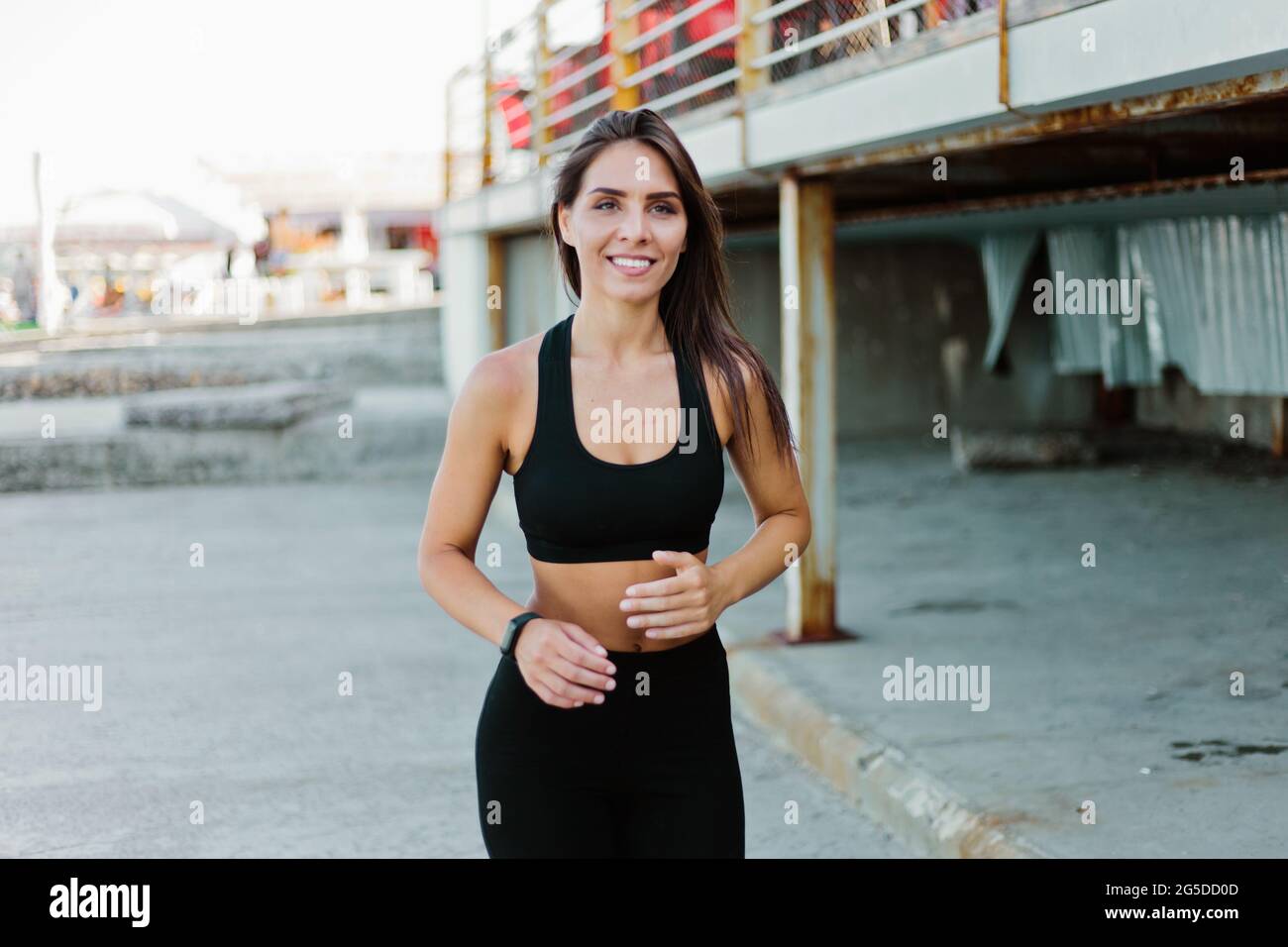 Fit woman in sportswear running outdoors at urban environment. Sports ...