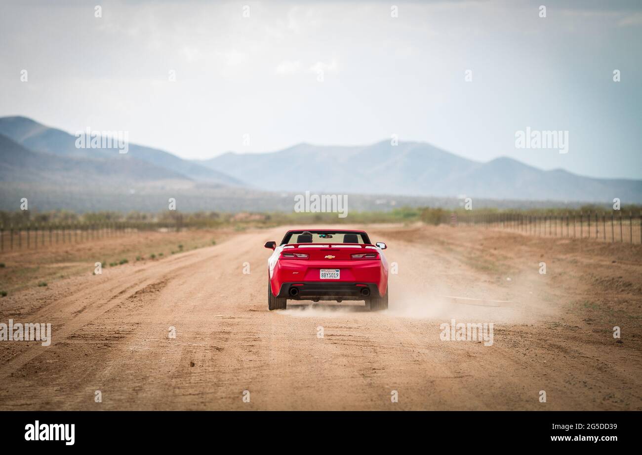 Red car driving in desert hi-res stock photography and images - Alamy
