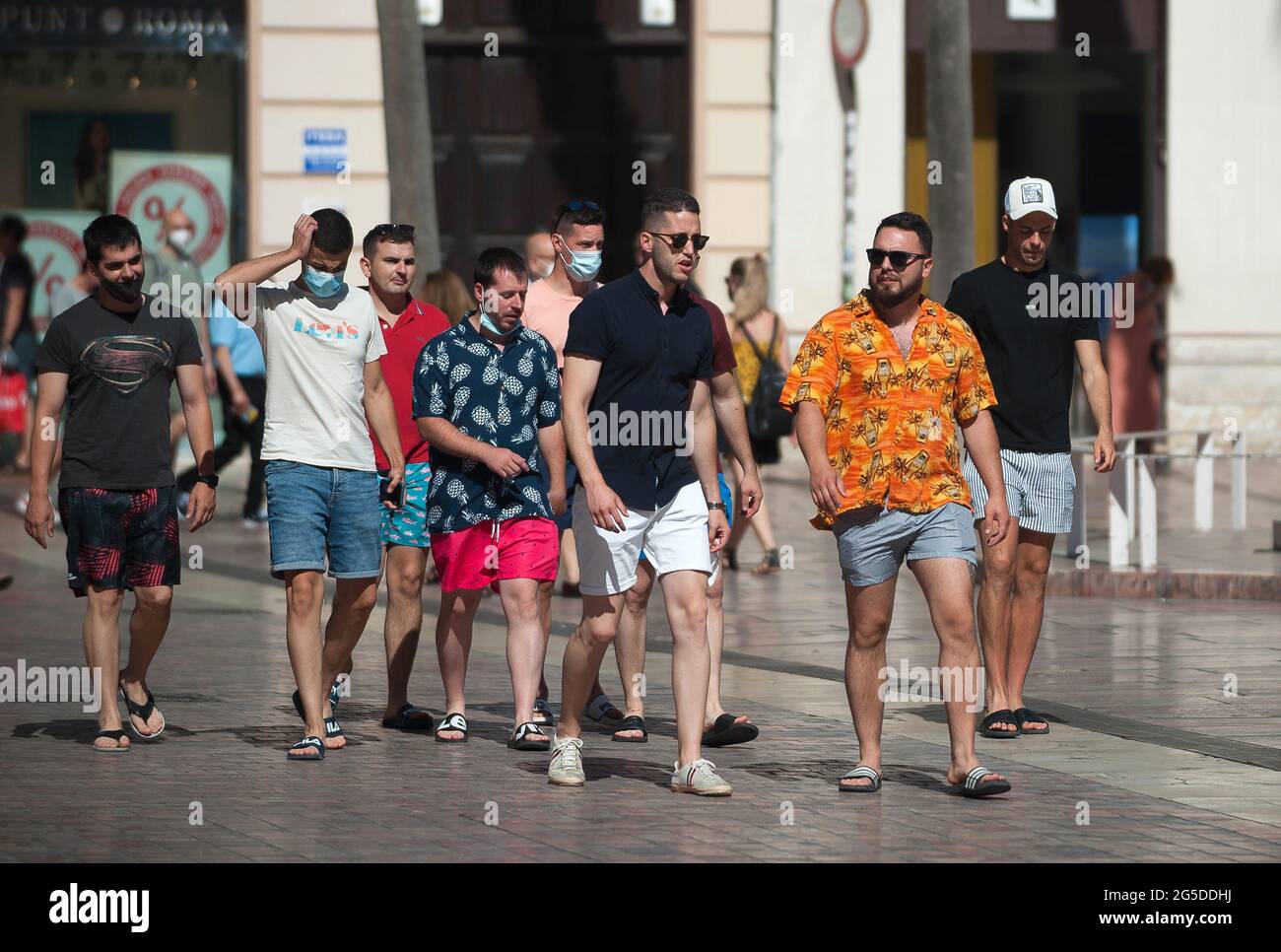 A group of people without face mask are seen walking along Plaza de la ...
