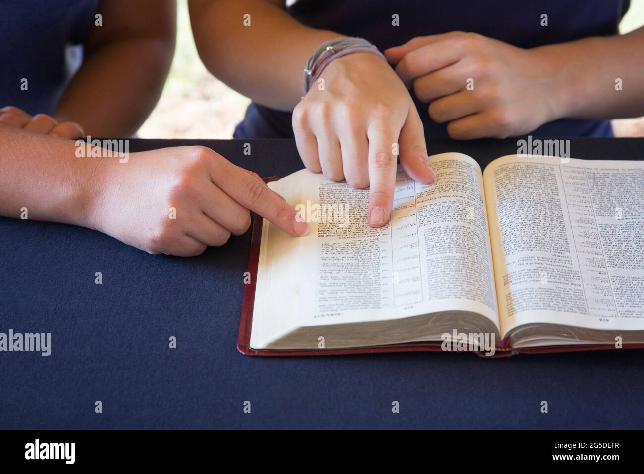 A Friend Helping Someone Study the Bible Stock Photo - Alamy