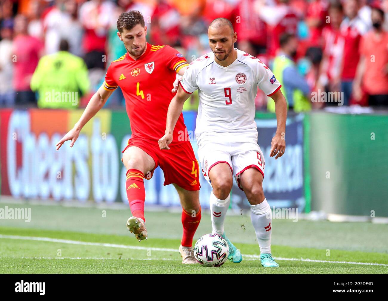 Wales' Ben Davies (left) and Denmark's Martin Braithwaite battle for ...