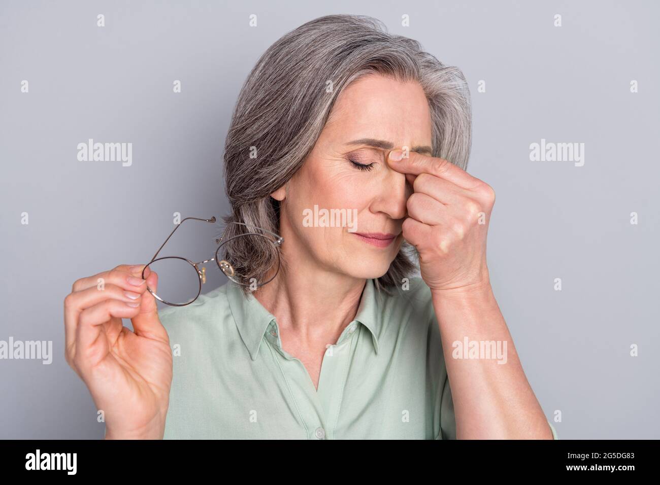 Portrait of depressed tired sick gray-haired woman feeling bad isolated ...