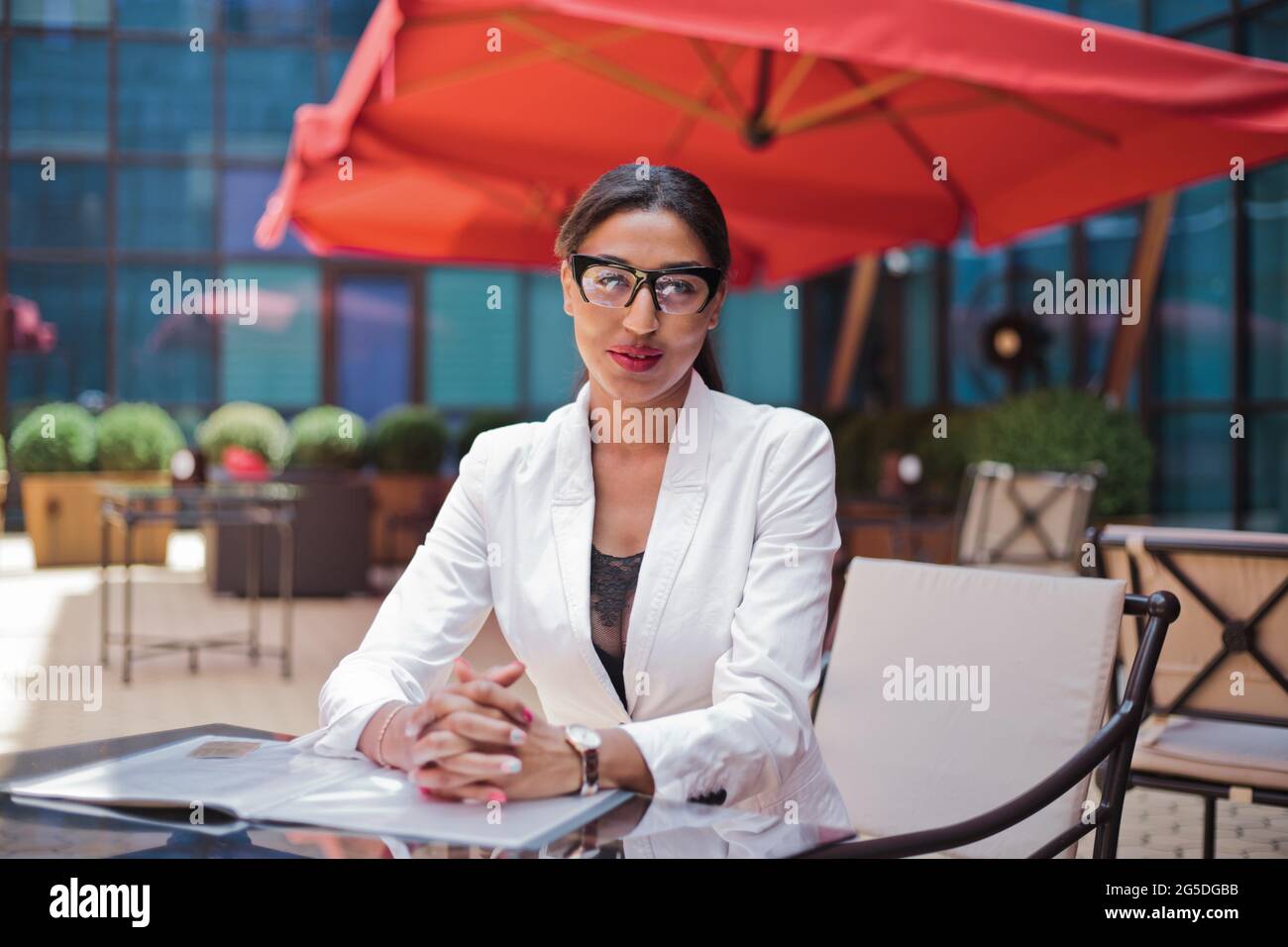 Afro business woman ready for interview while sitting at table in ...