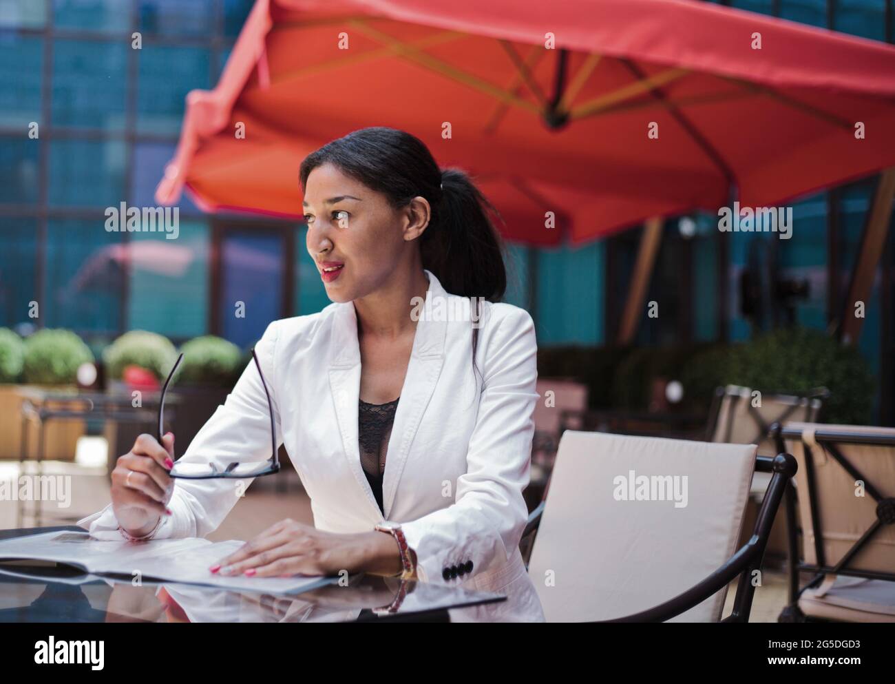 Smilling afro business woman ready for interview while sitting at table ...