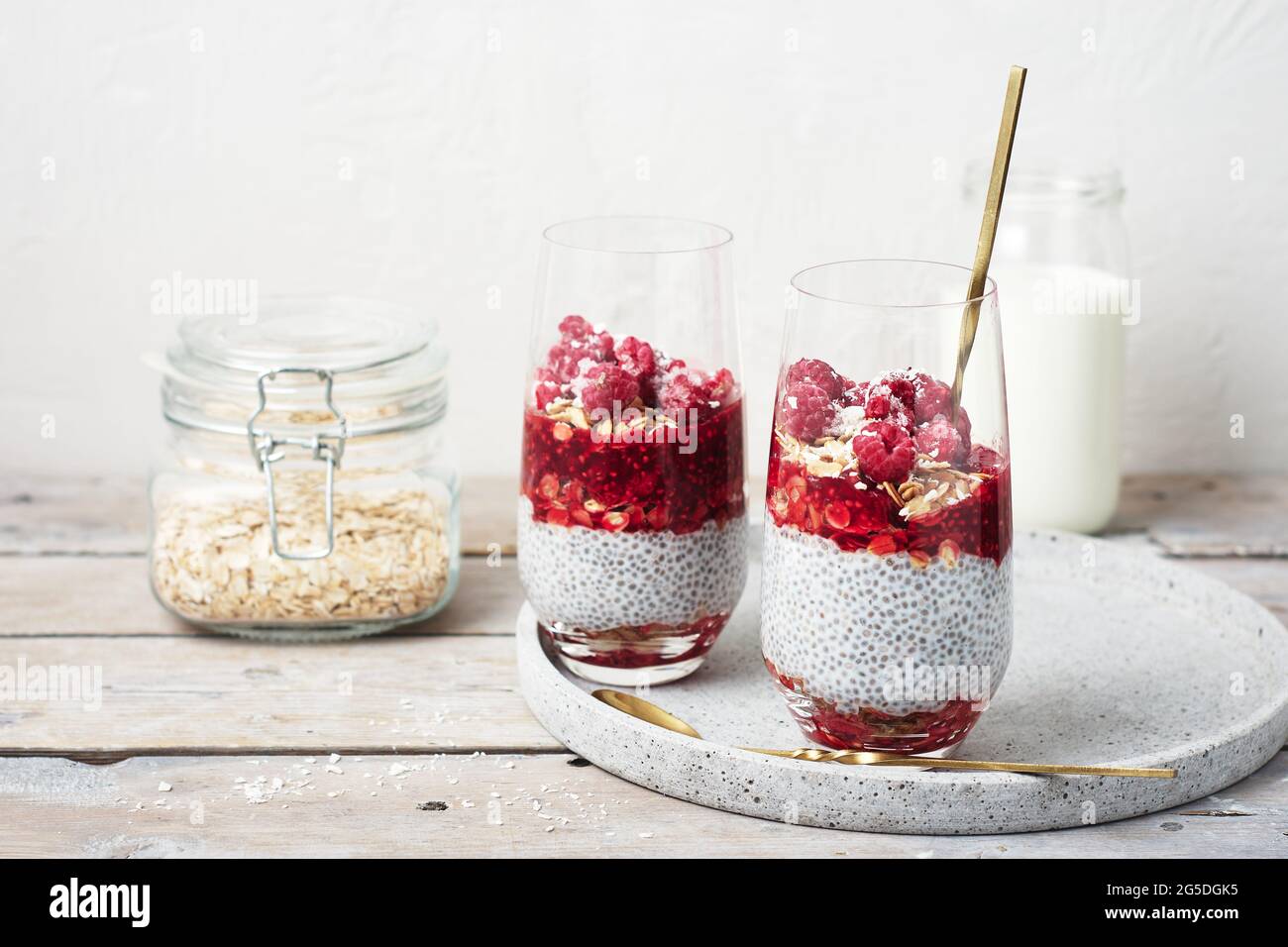 Two glasses of chia pudding with granola and raspberries Stock Photo ...