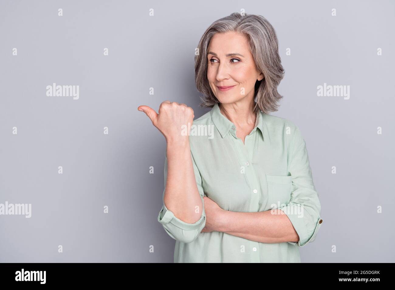 Photo of happy positive smiling dreaming mature woman point finger ...