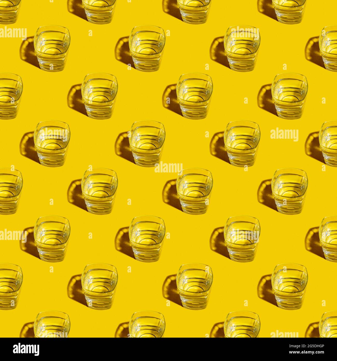 Seamless pattern of glasses with water on a yellow background. For ...