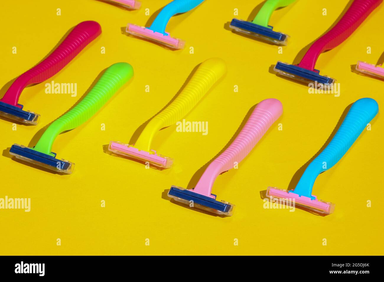 Beauty and fashion pop art concept. Many colored plastic razors on a ...