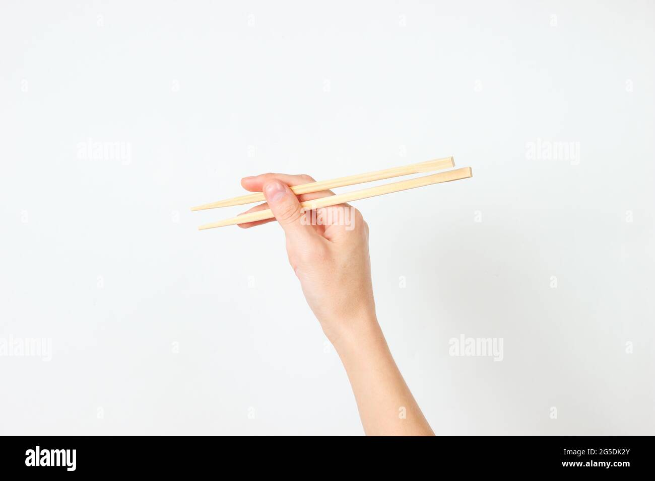 Female hand hold chopsticks on white background. Minimalistic food ...