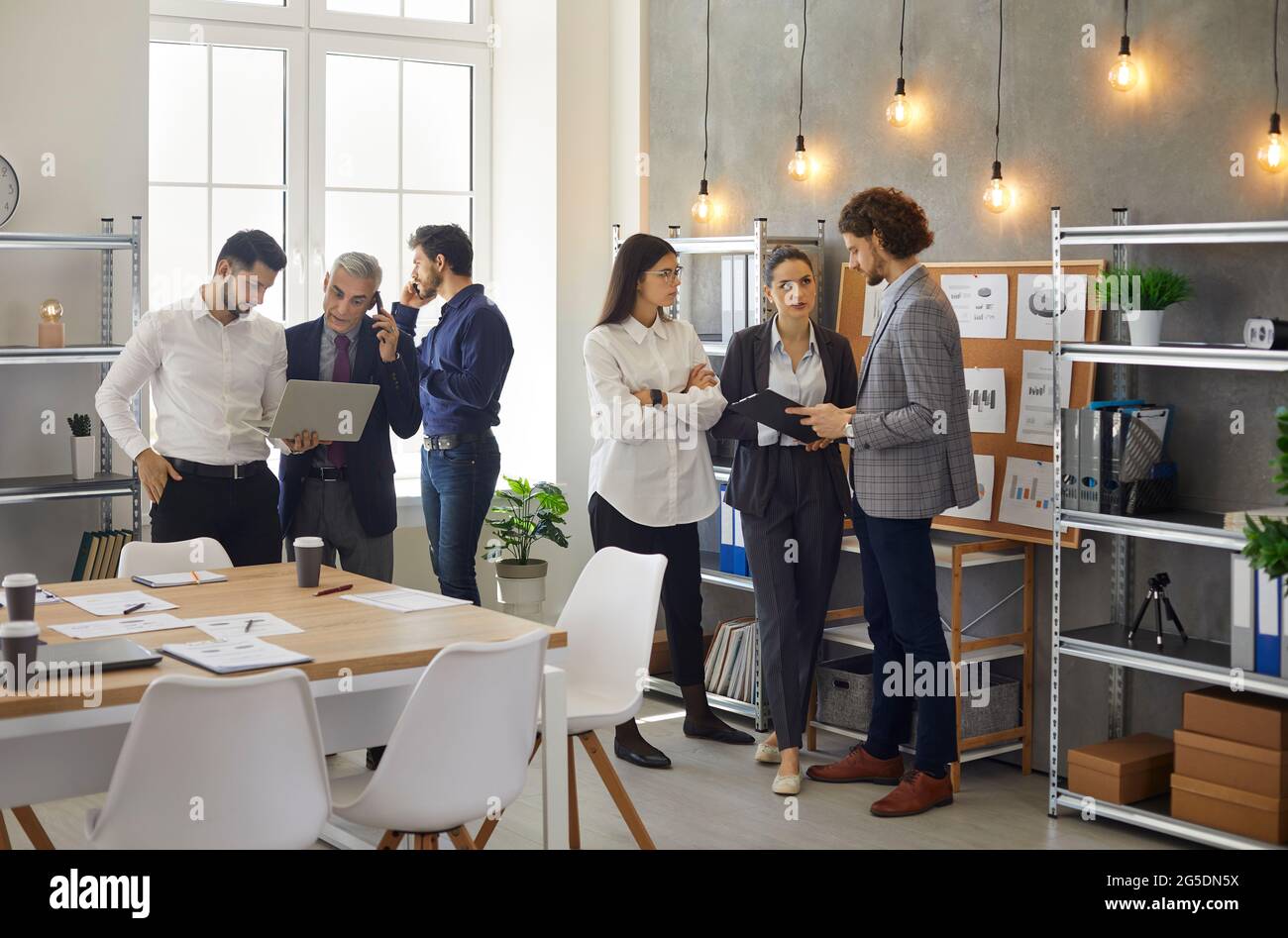 Groups of company workers meet in modern office to discuss current work ...